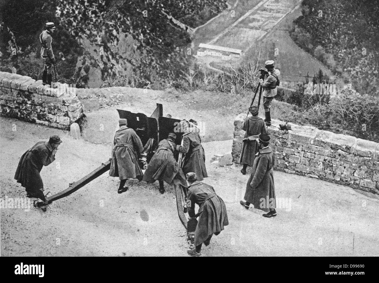 Italian gun about to fire on Austrian position across an Alpine valley ...