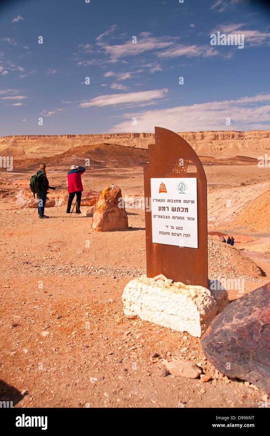 Photographer on rim of Ramon Crater at Makhtest Ramon Nature Reserve ...