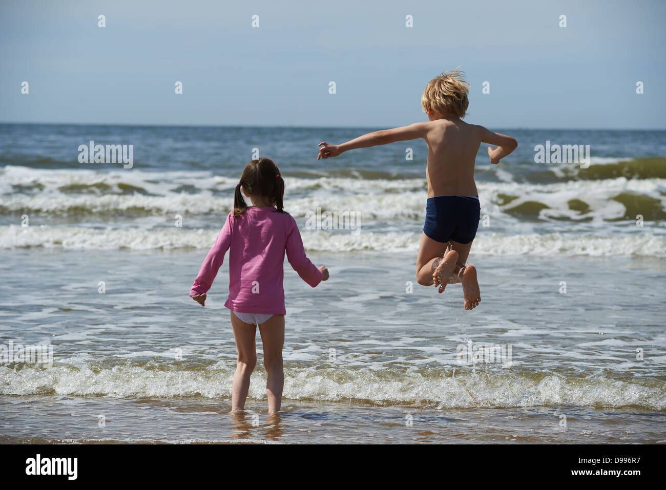 Children jumping into the sea hi-res stock photography and images - Alamy