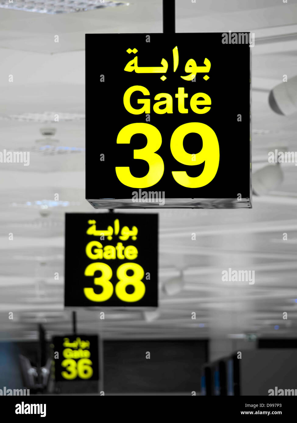 Gate signs in the airport building written in Arabic language, for ...