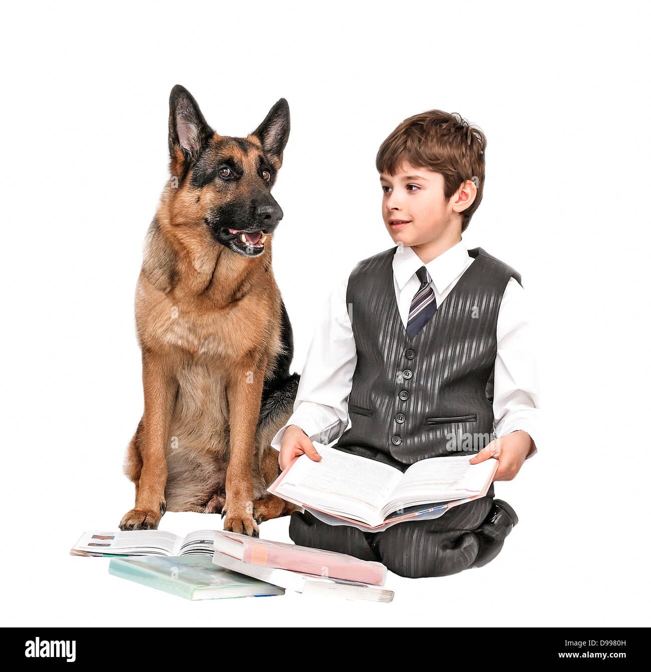 The boy, a pupil of the school and the dog, a German Shepherd read ...