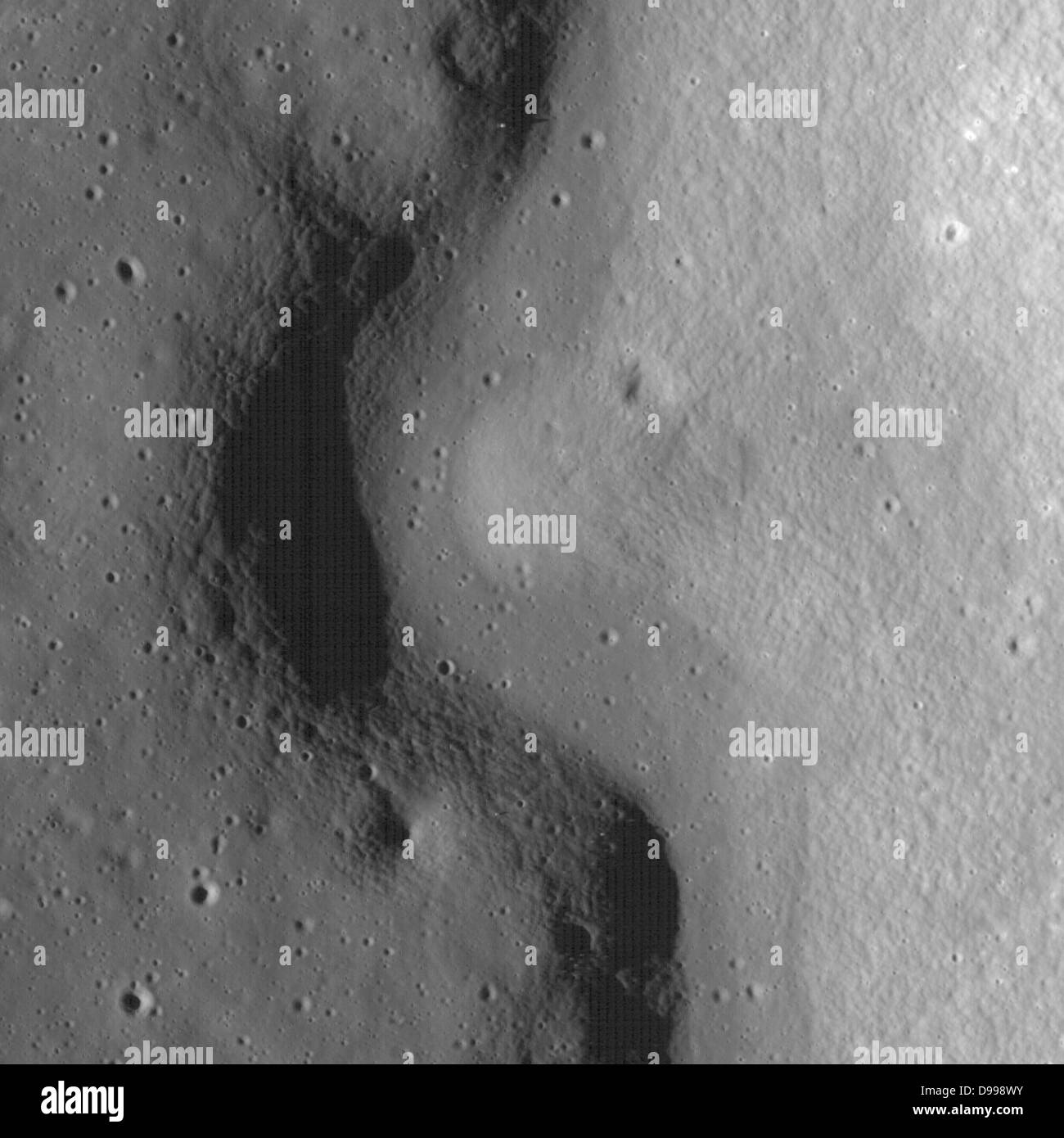 A sinuous rille created by a lava flow snakes around the base of a ...