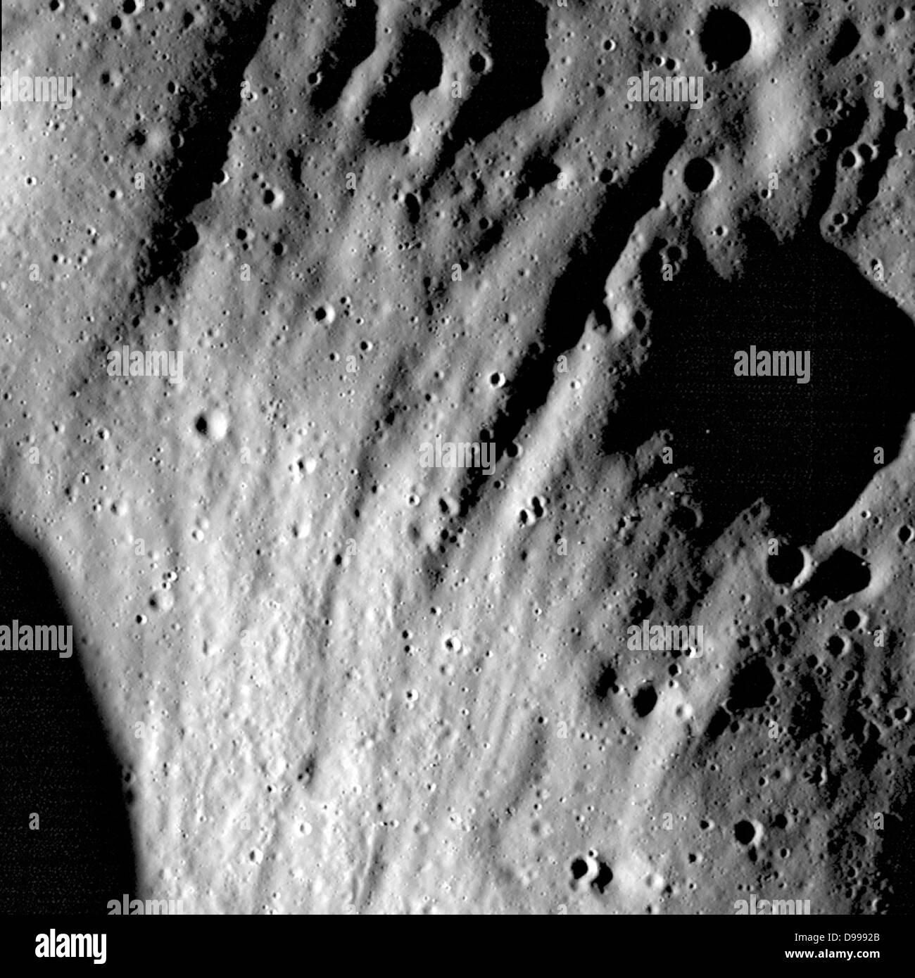 Ejecta scours deep grooves into the walls and rim of an unnamed crater ...
