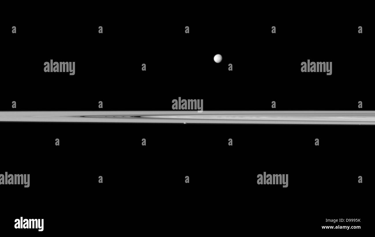 Saturn's small moon Prometheus appears embedded within the planet's ...
