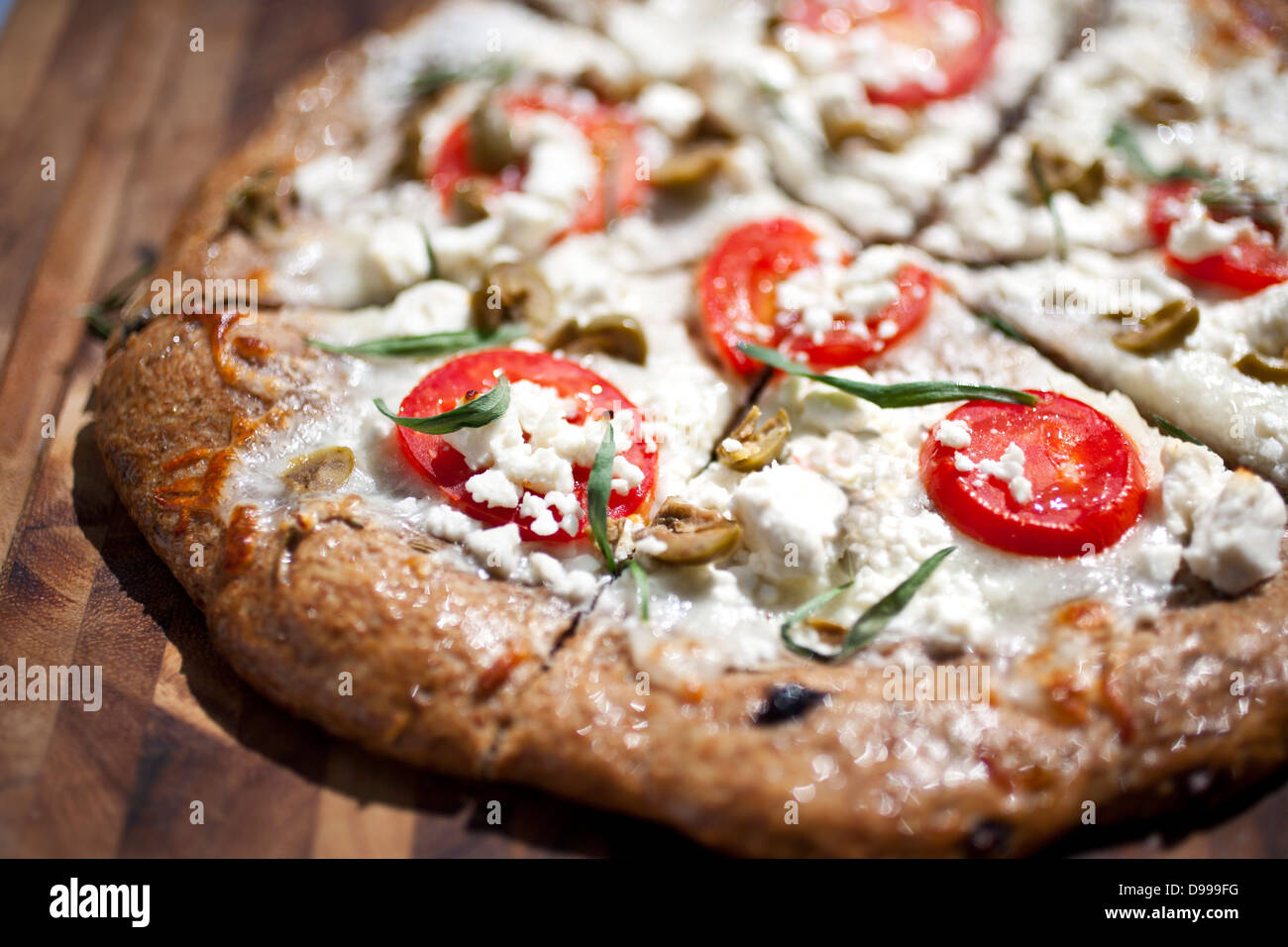 rustic white cheese pizza with tomatoes sliced on cutting board Stock ...