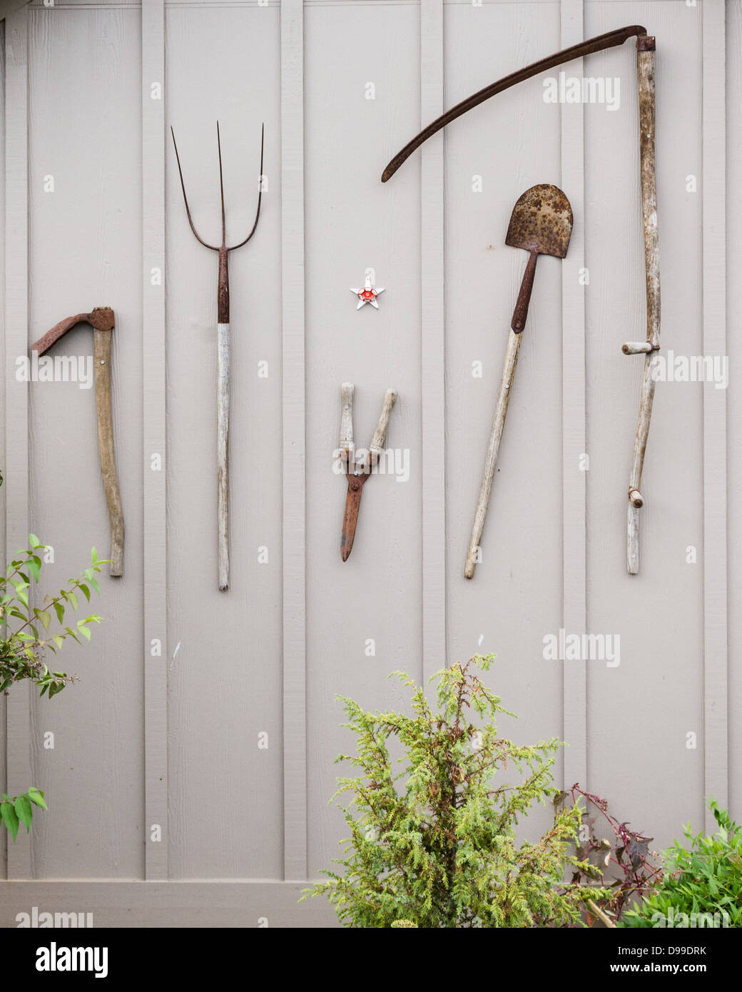A group of tools hanging on the shed wall Stock Photo - Alamy