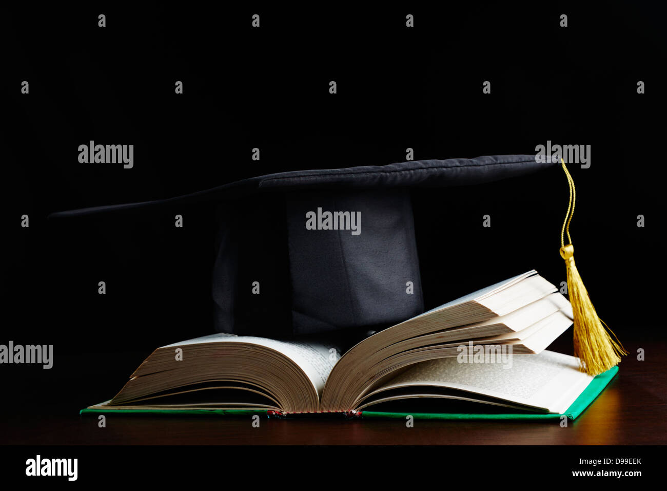 Education opened book graduation cap hi-res stock photography and ...
