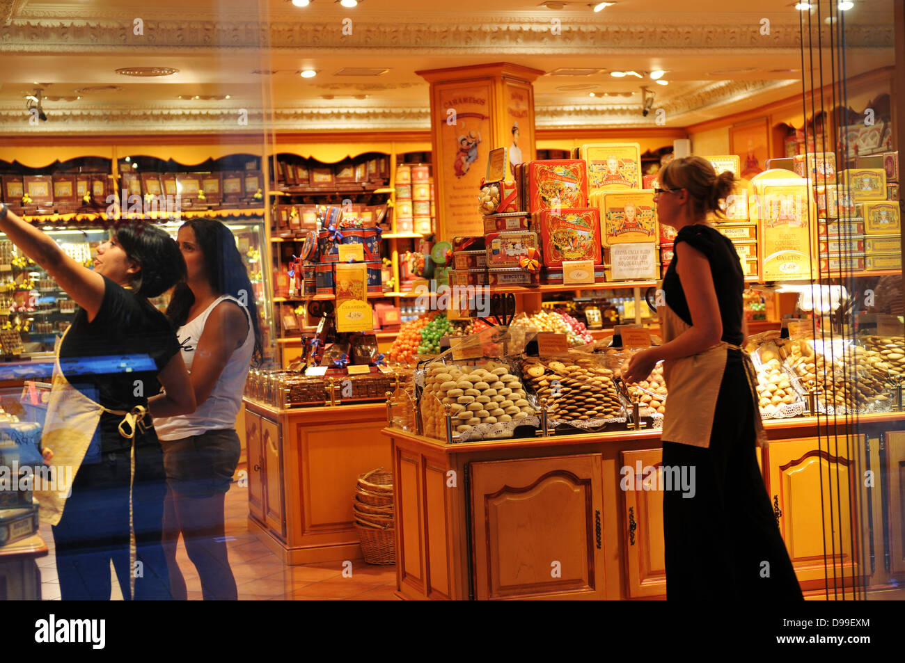 Barcelona, Spain - 6 July, 2012: Tourists shopping inside sweets shop ...