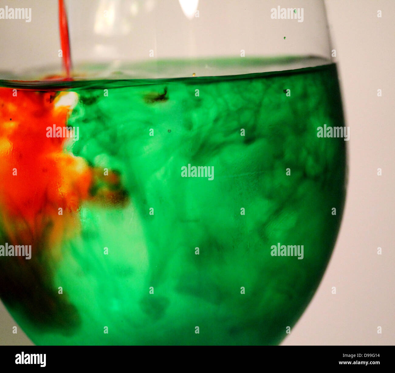 Ink being poured into a glass of water Stock Photo - Alamy