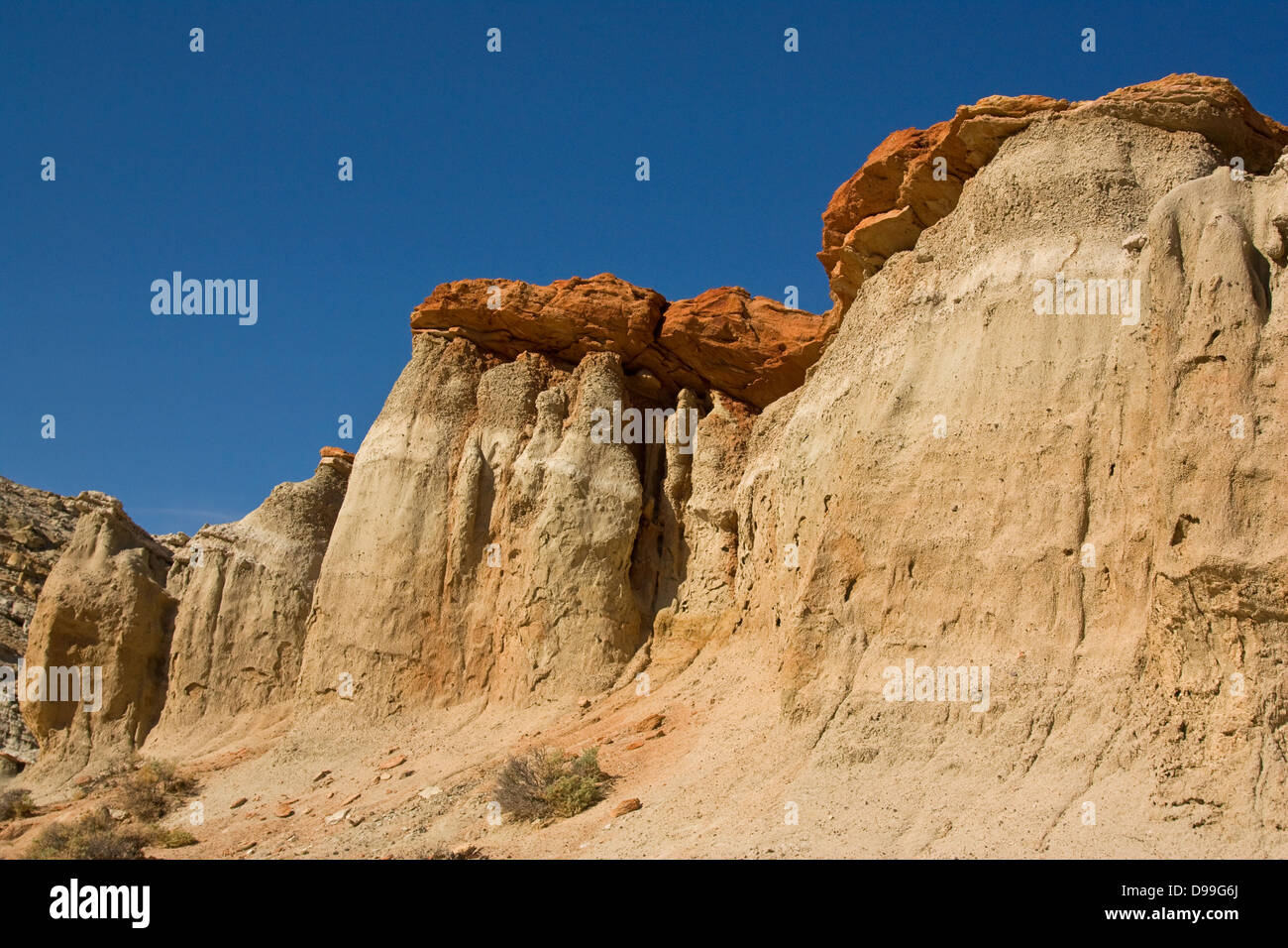 Siltstone cliff covered with a layer of sandstone Stock Photo - Alamy