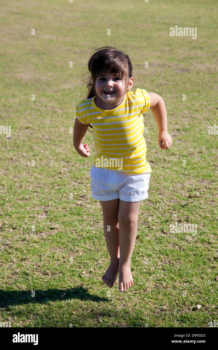 Girl Jumping on Grass Stock Photo - Alamy