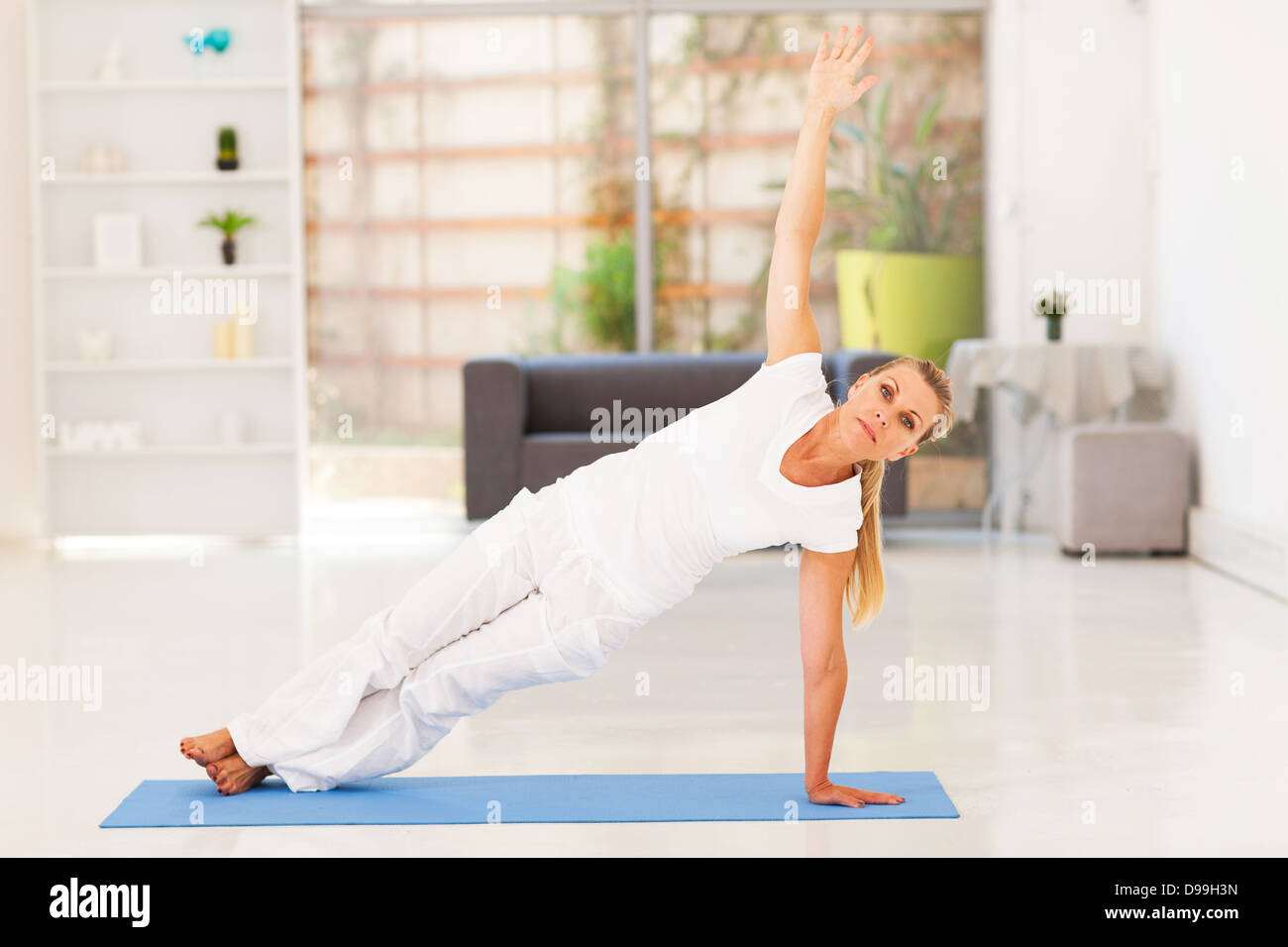 middle aged woman doing fitness exercise at home Stock Photo - Alamy