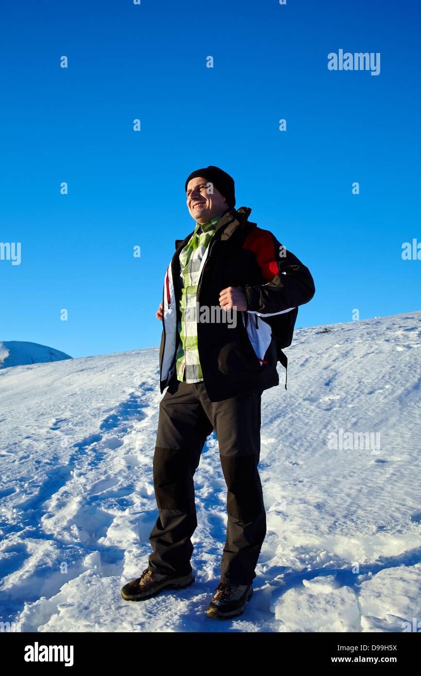 Young man on the mountain in the winter holiday Stock Photo - Alamy