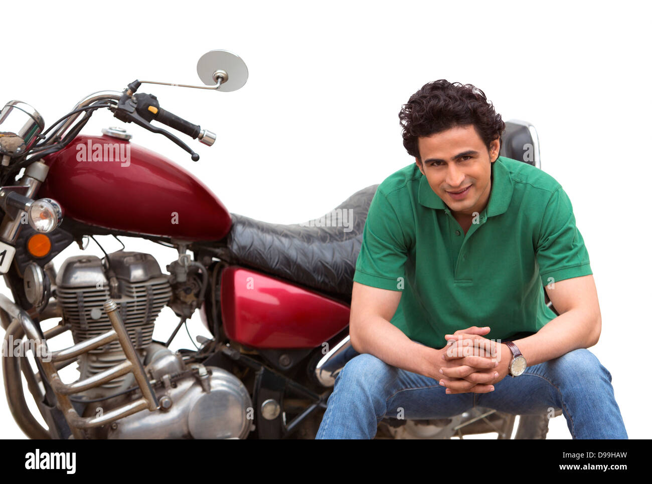 Portrait of a man sitting beside a motorcycle and smiling Stock Photo ...
