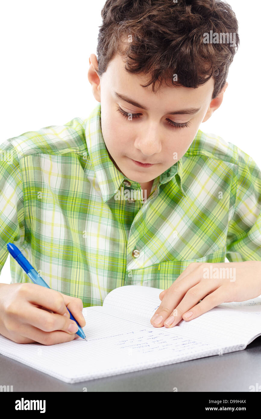 Caucasian student boy at his desk writing for homework Stock Photo - Alamy