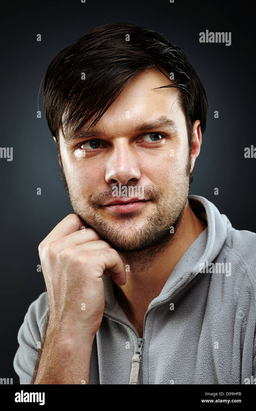 Low key studio portrait of an pensive handsome young man Stock Photo ...