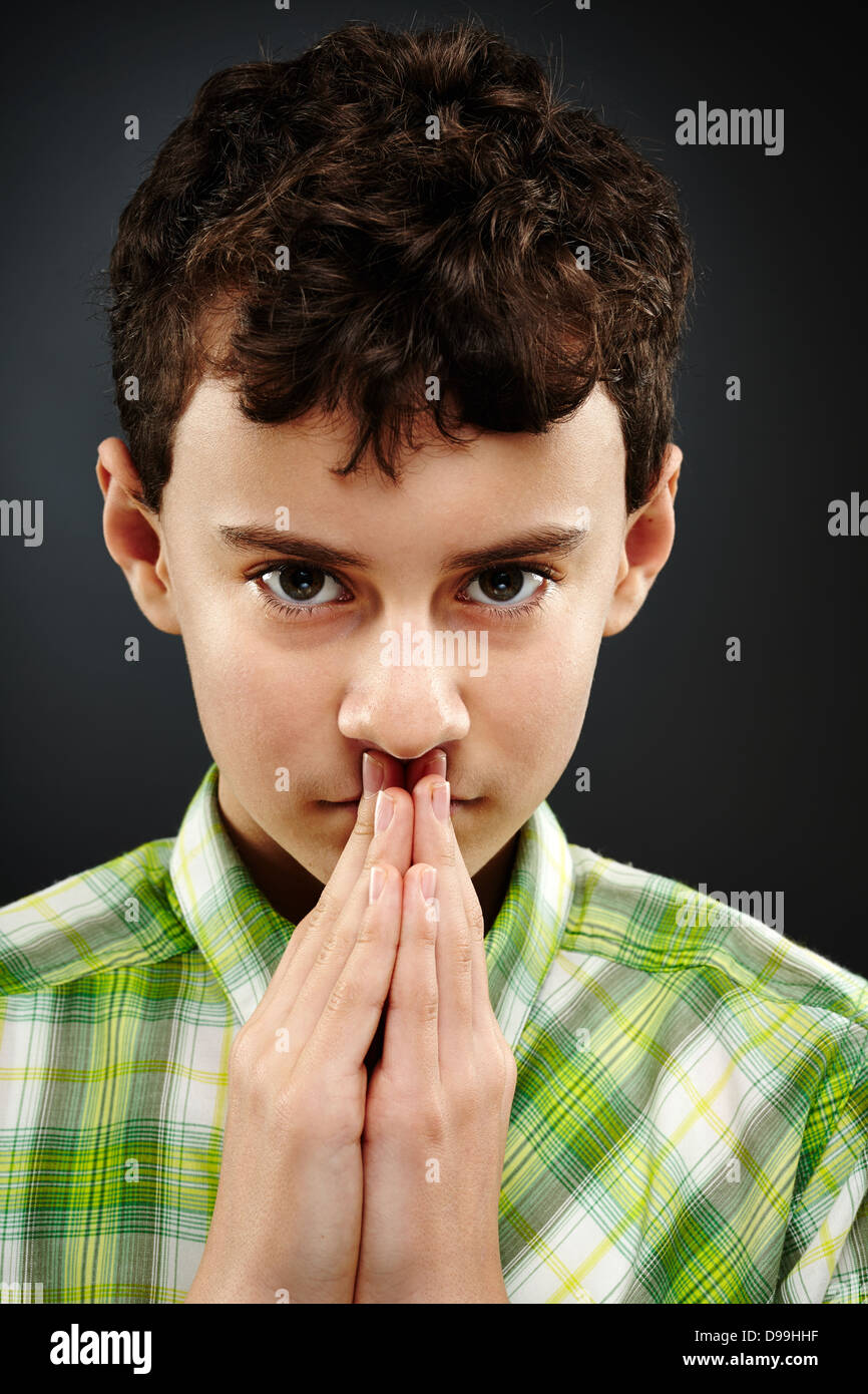 Closeup portrait of a pensive boy over gray background, studio shot ...