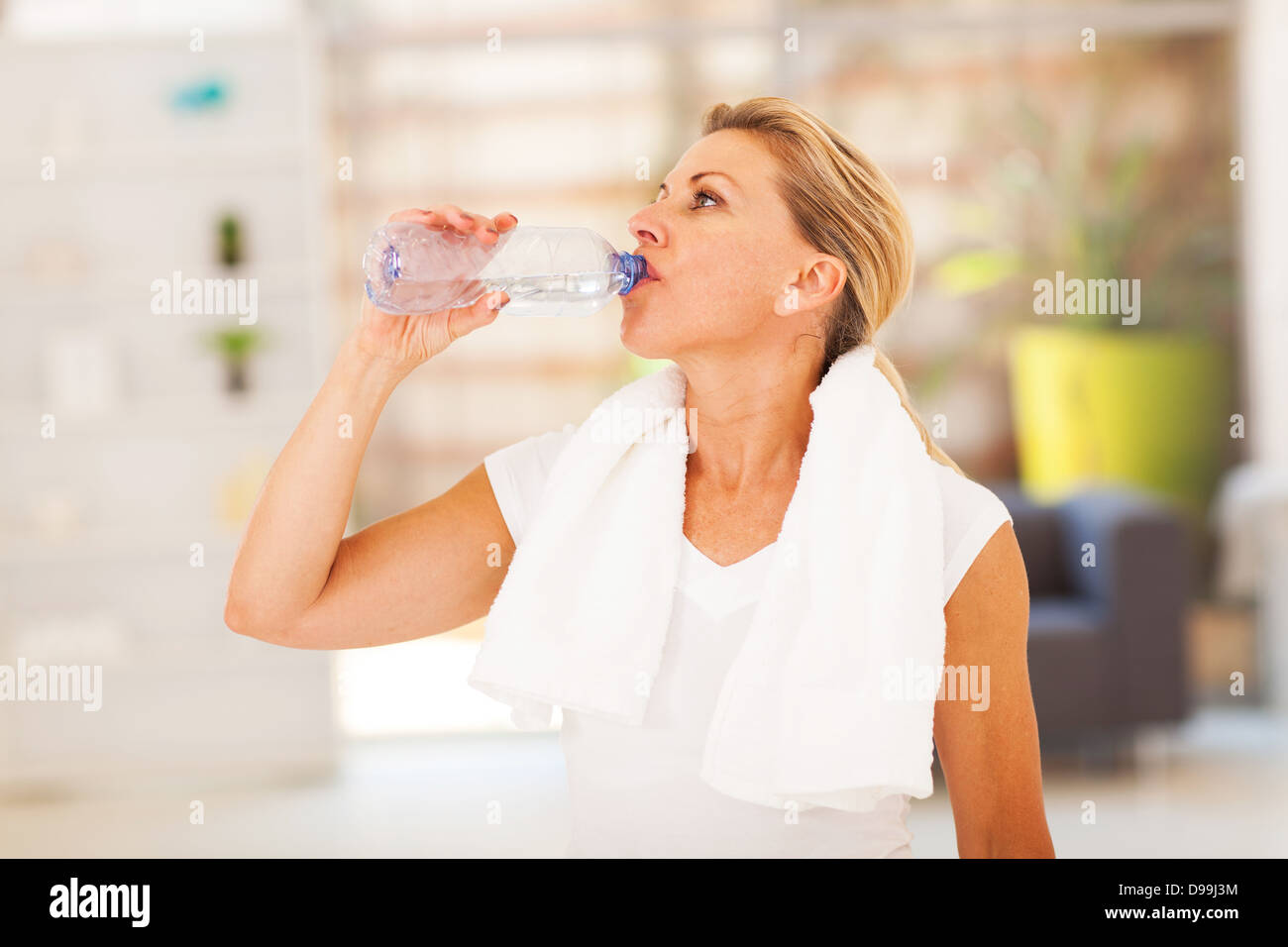 fitness mature woman drinking water after exercise Stock Photo - Alamy