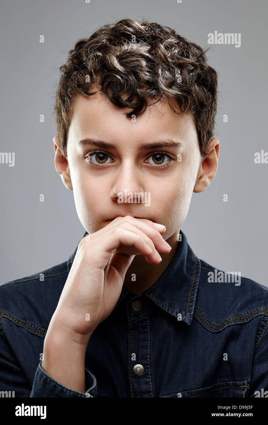 Big brown eyed boy sharing a deep thoughtful expression looking ...