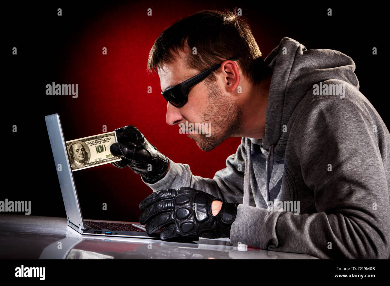 Hacker in a sunglasses with laptop and money in hand Stock Photo - Alamy