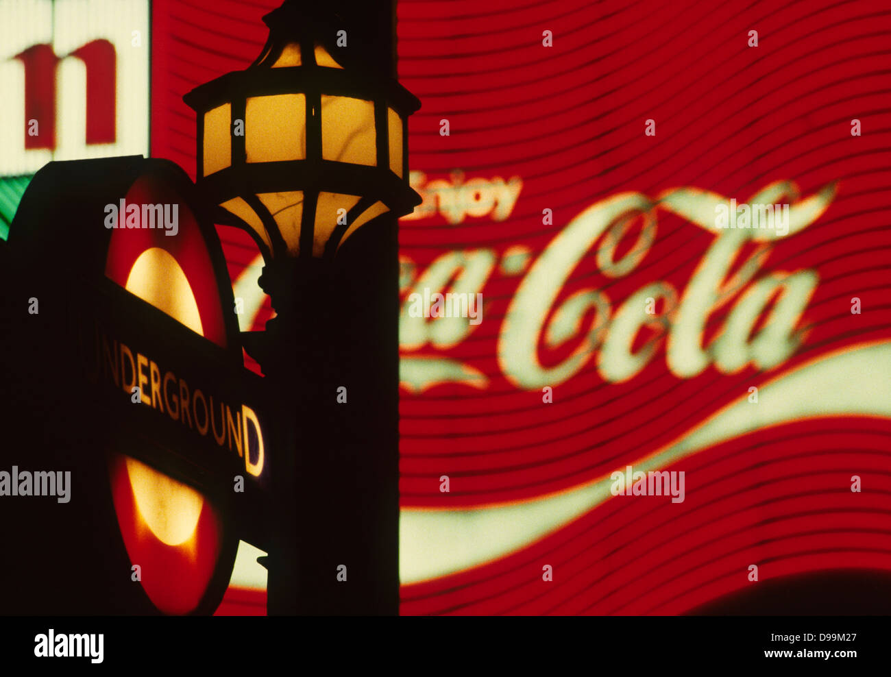 Piccadilly Circus neon signs with street light and Underground sign ...