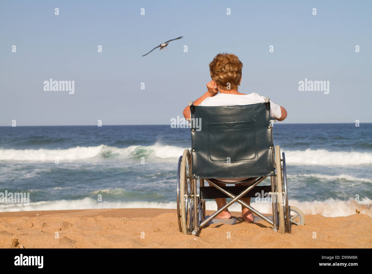 lonely disabled senior woman on beach Stock Photo - Alamy