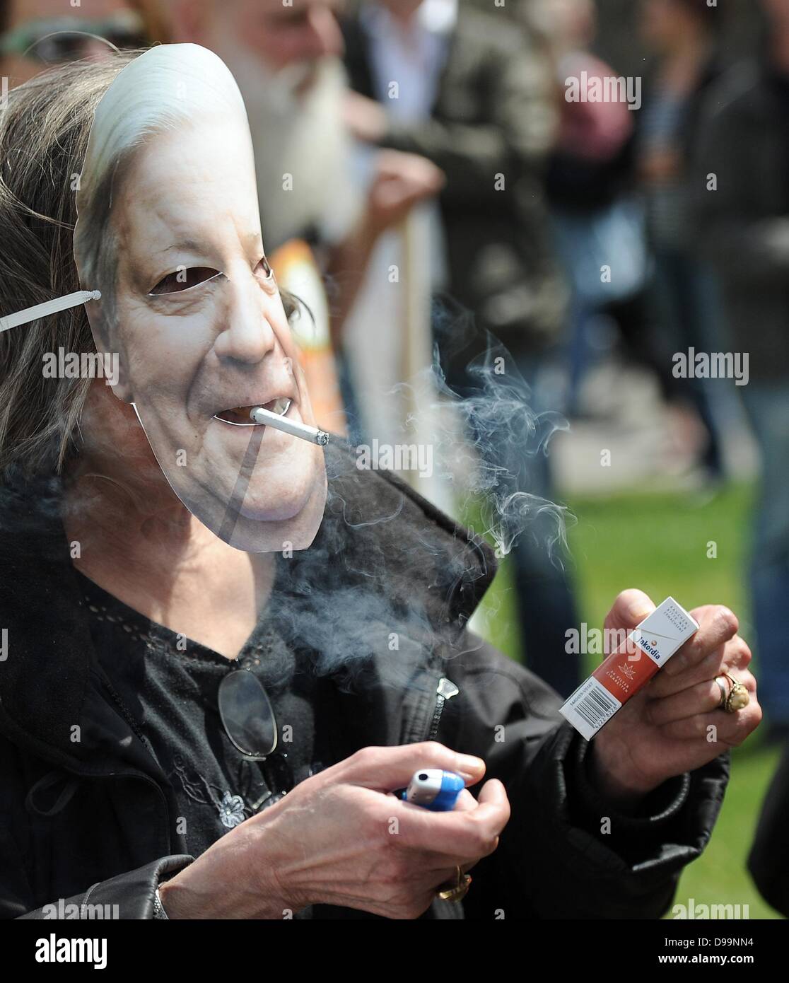 Demonstrators wear masks with the picture of former German Chancellor ...