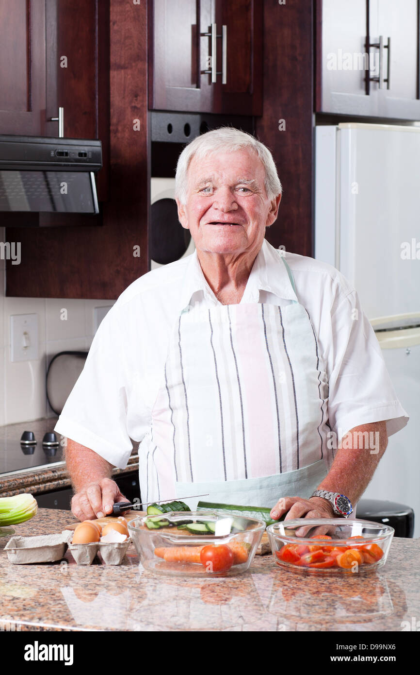 happy senior man cooking in kitchen Stock Photo - Alamy