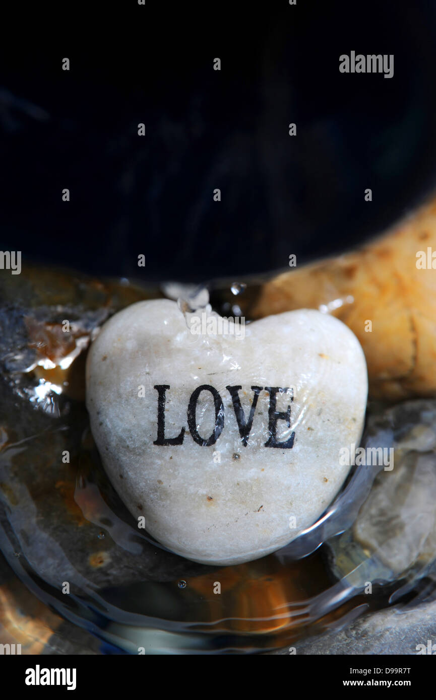 Heart of Stone a heart shaped stone with the word Love painted on in a ...