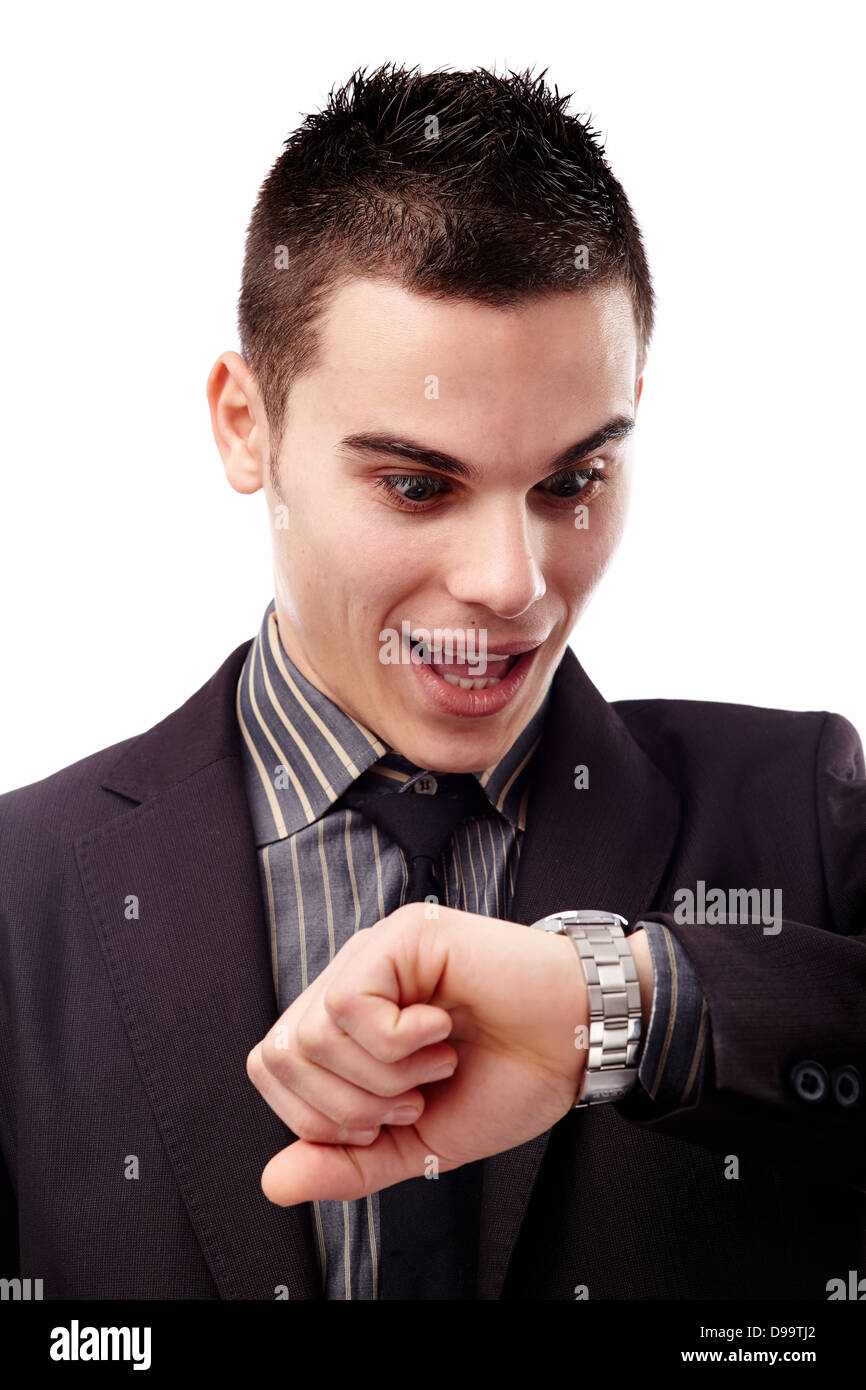 Young man looking at his wristwatch in full length pose, isolated on ...
