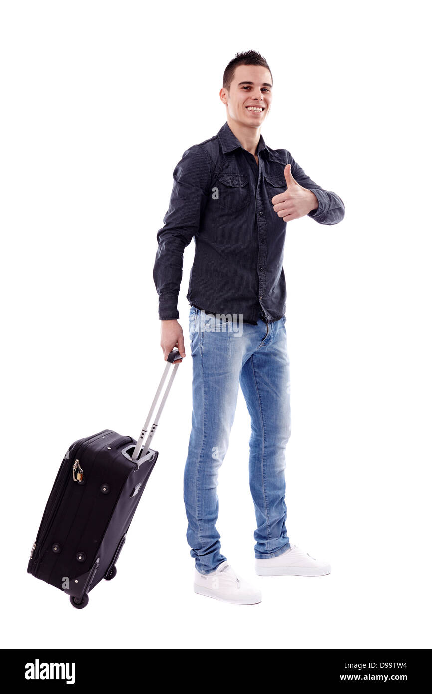Happy young traveler carrying his luggage in full length pose, isolated ...