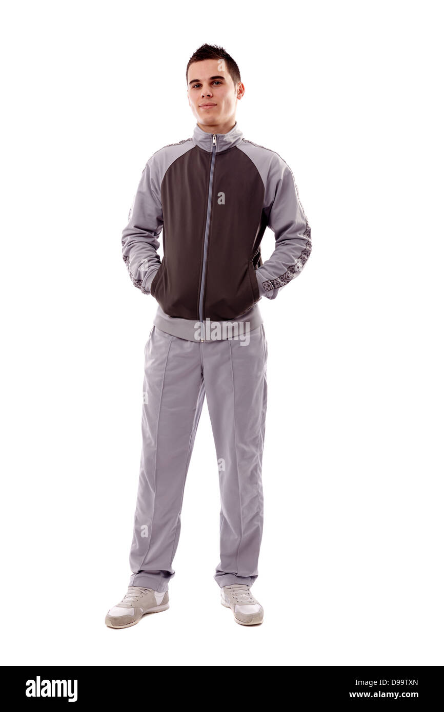Young man in track-suit and sneakers in full length pose, isolated on ...