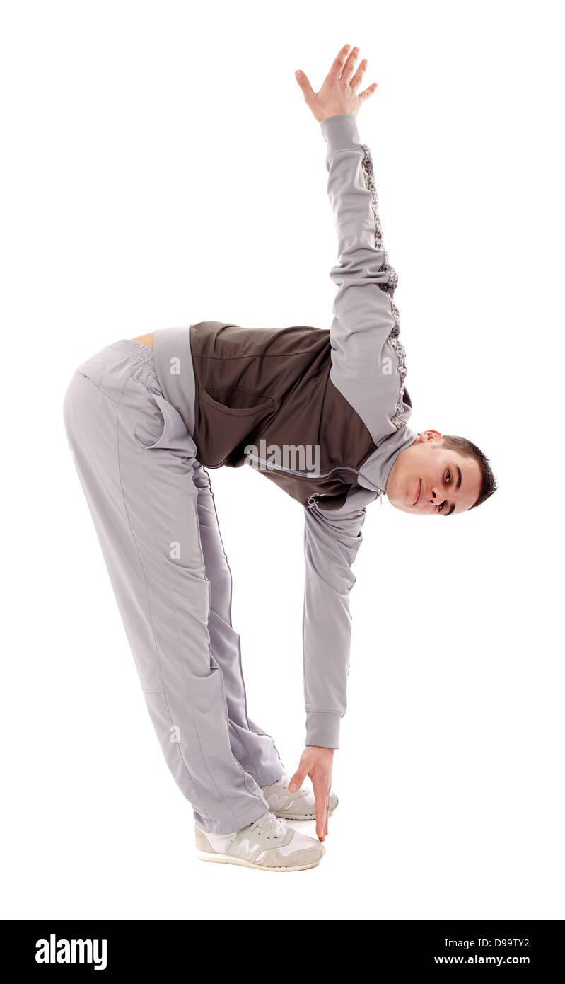 Full length pose of a young man stretching, wearing a track-suit and ...