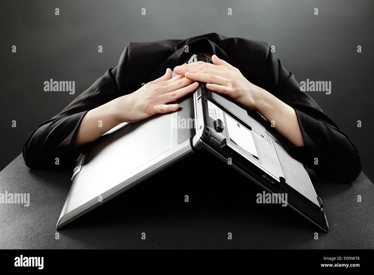 Stressed businesswoman with her laptop on her head in closeup pose, on ...