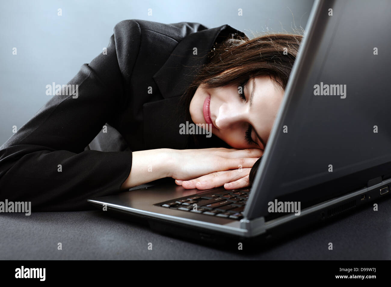Tired businesswoman sleeping on her laptop keyboard in closeup pose, on ...