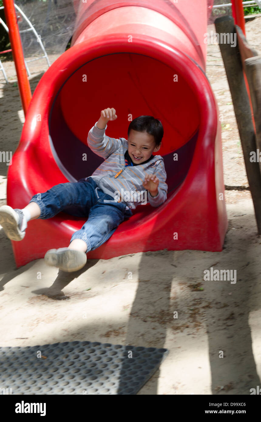 Young boy playing in playground Stock Photo - Alamy