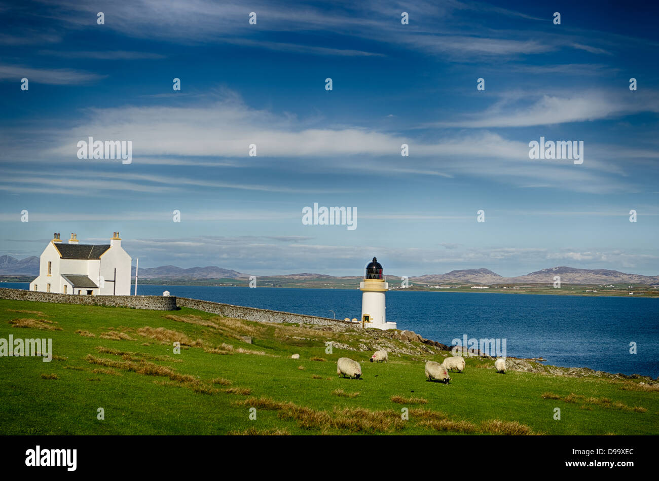 Loch Indaal lighthouse and light keepers cottage with the isle of Jura ...