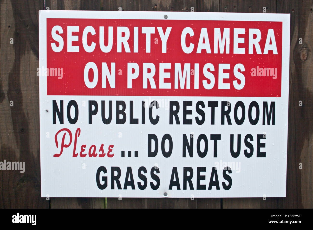 Security camera and no restroom sign Stock Photo - Alamy