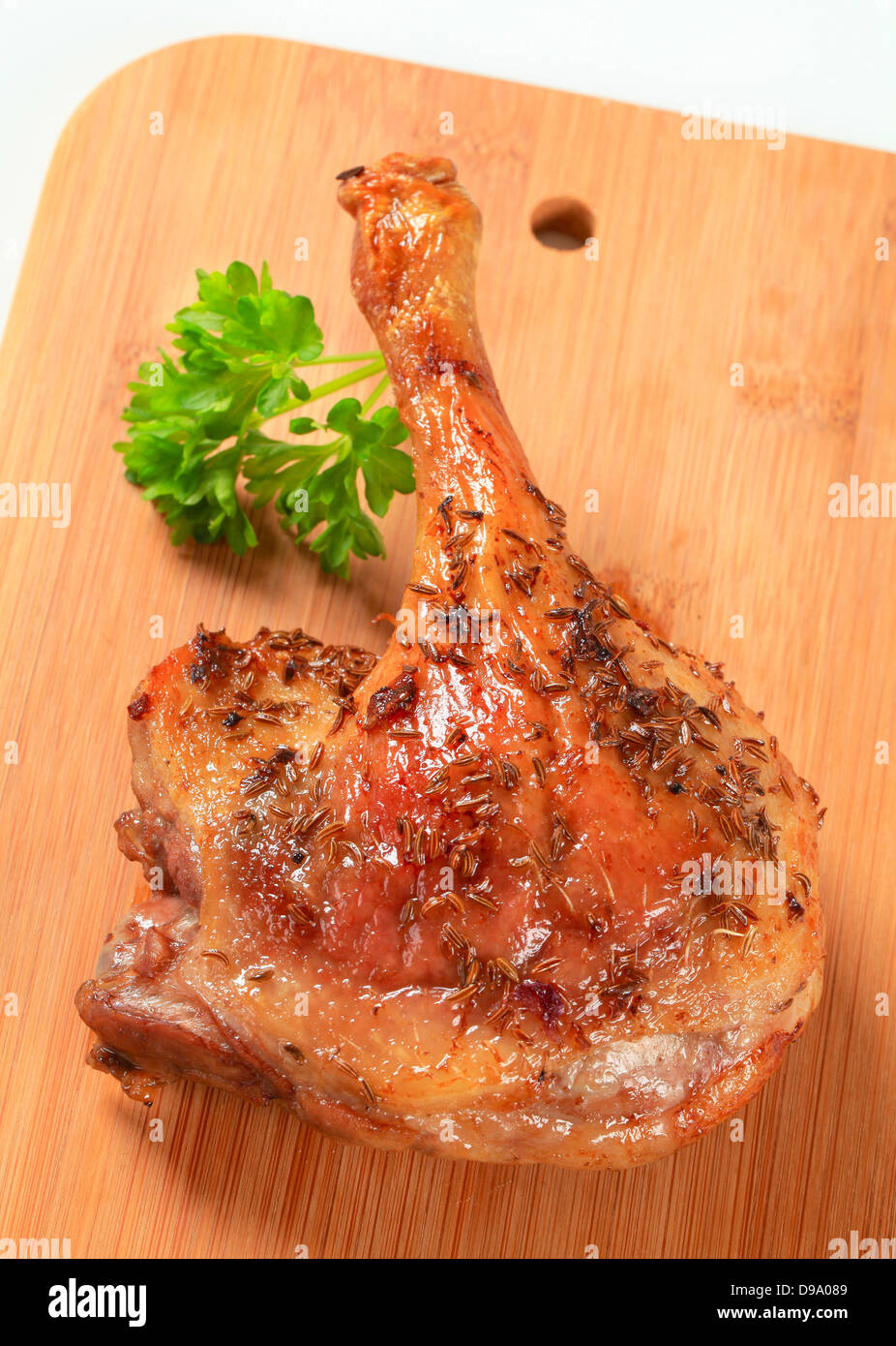 Roast duck leg topped with caraway seeds Stock Photo - Alamy