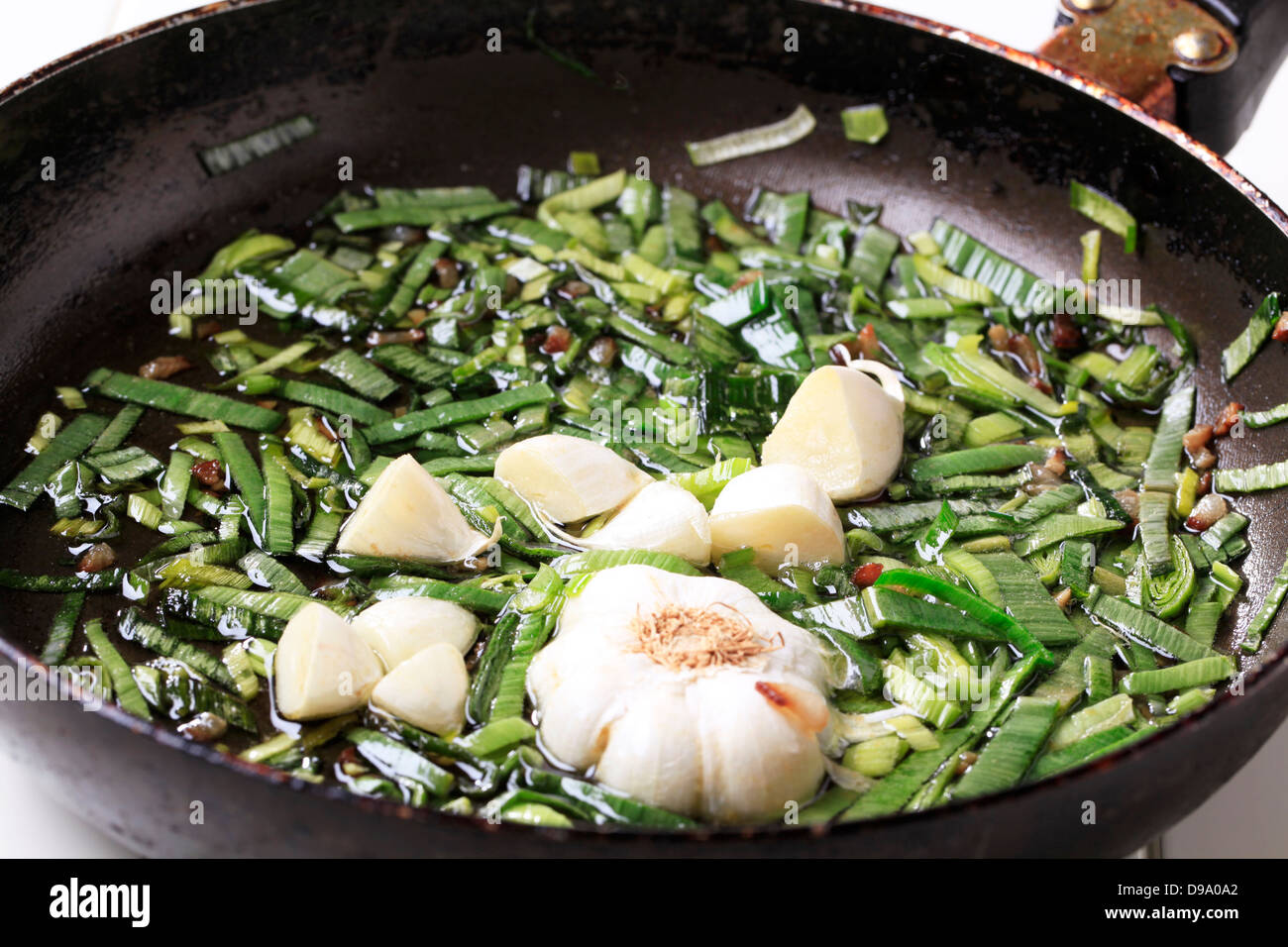 Sauteing leek and garlic on a pan Stock Photo - Alamy