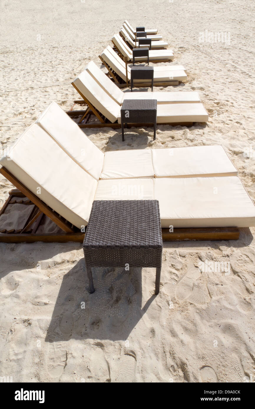 Rows of several lounge chairs on the beach Stock Photo - Alamy