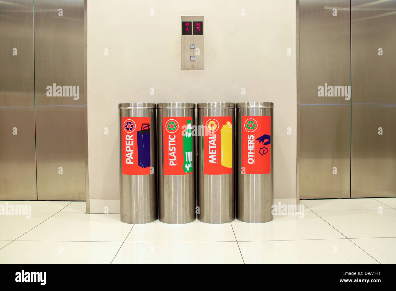 Recycle dustbin beside elevator opening Stock Photo - Alamy