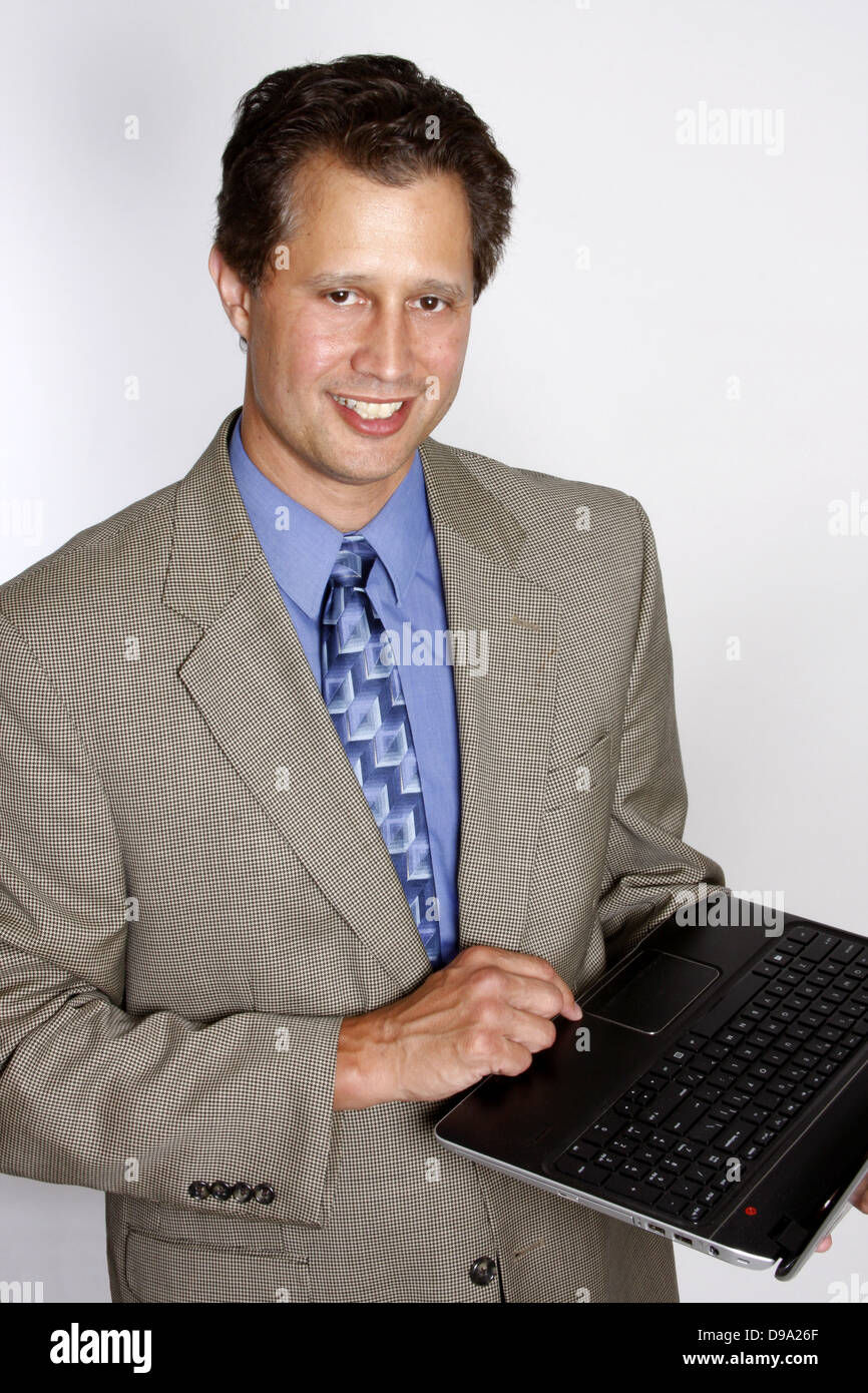 A business man working on a laptop computer Stock Photo - Alamy