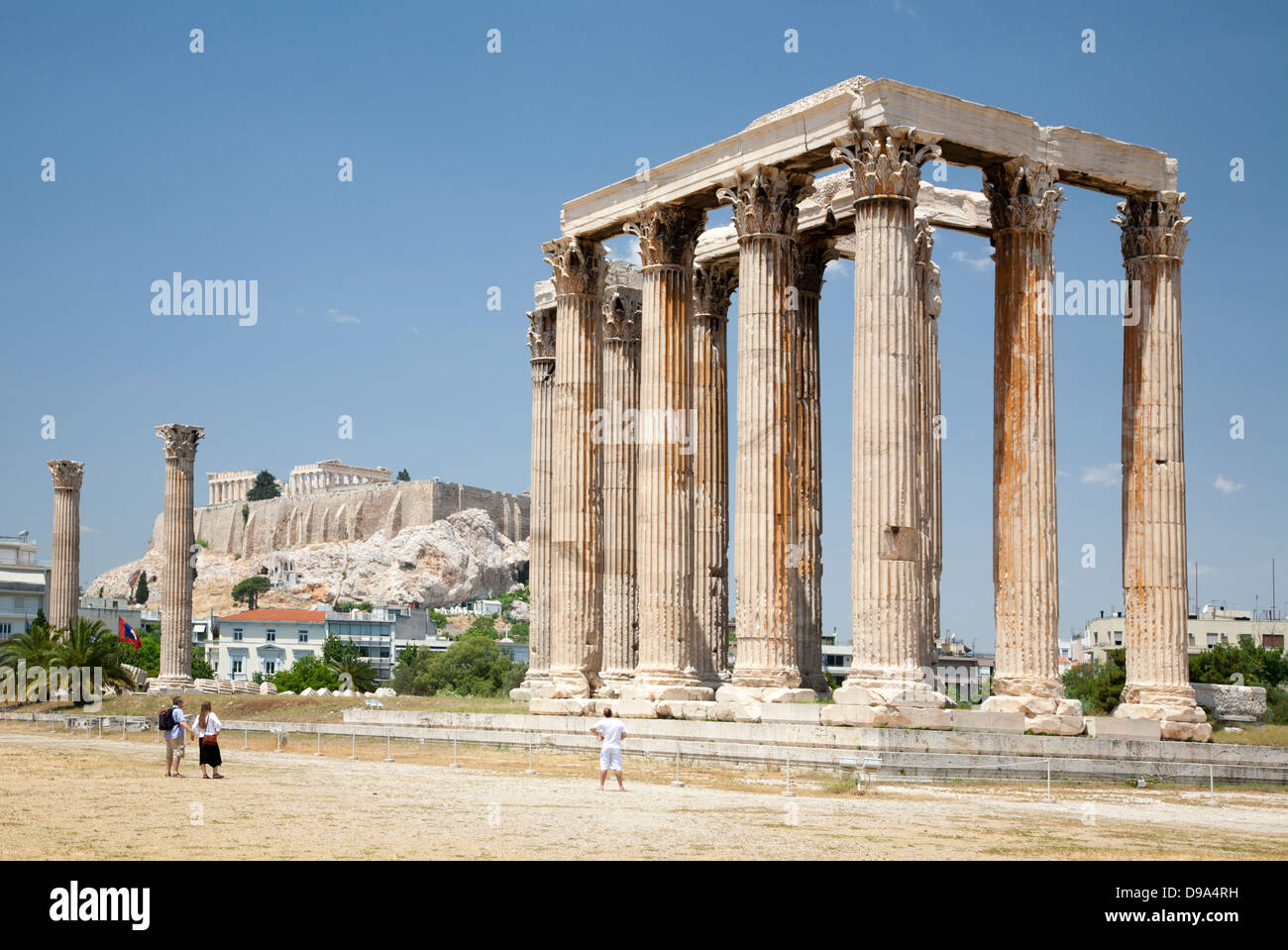 Tourists viewing the Temple of Olympian Zeus with the Parthenon and ...