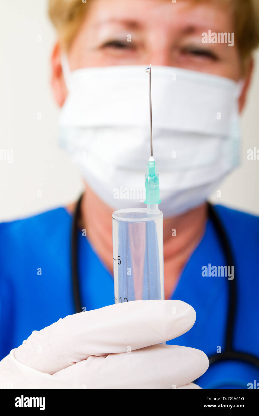 female senior nurse holding syringe Stock Photo - Alamy