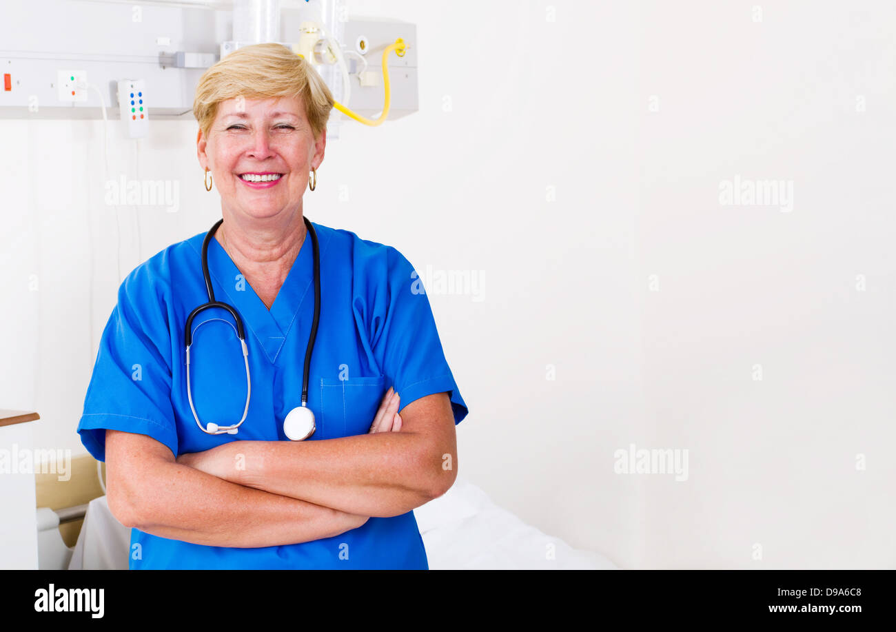 Joyful senior doctor crossed arms hi-res stock photography and images - Alamy