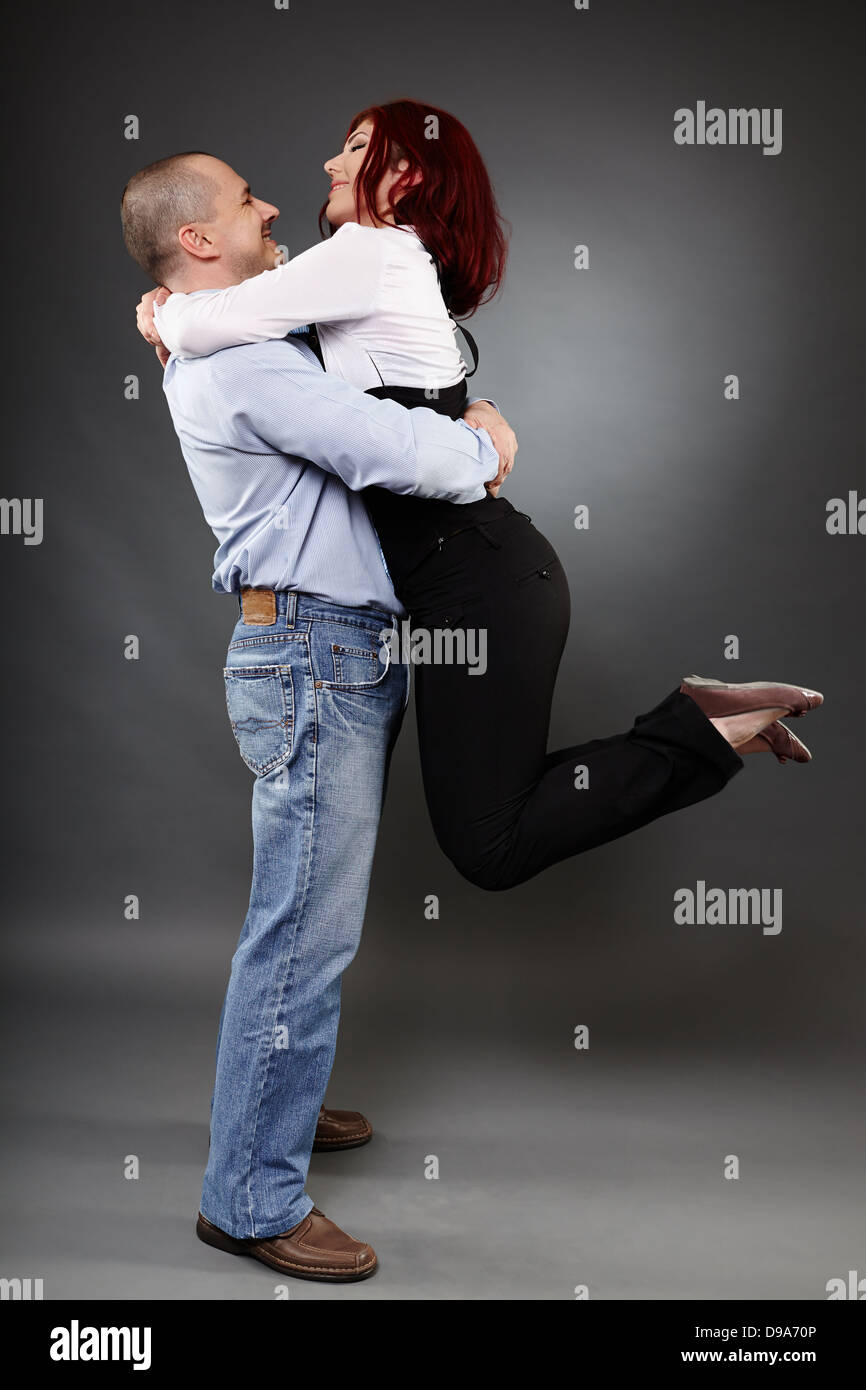 Full length portrait of a business couple hugging Stock Photo - Alamy