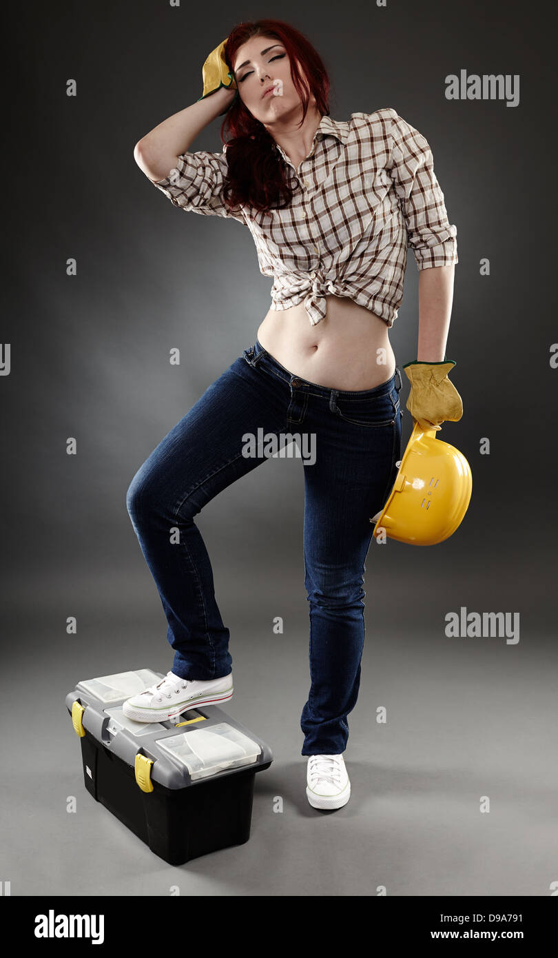 Over worked construction lady, full length on gray background Stock ...