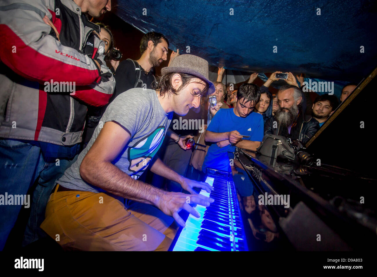 German pianist Davide Martello plays piano in pouring rain at the ...