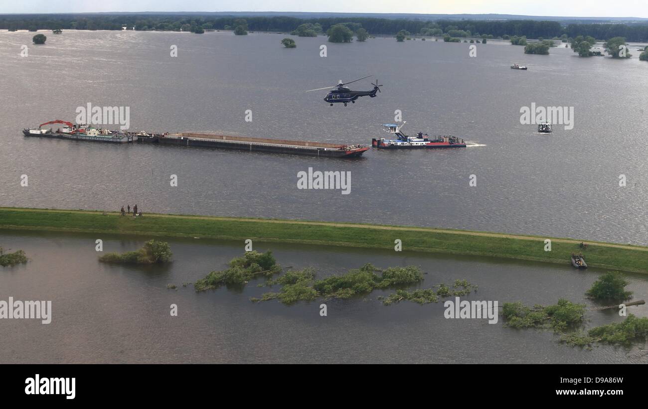 A helicopter circles over a dam of the Elbe in Fischbeck, Germany, 15 ...